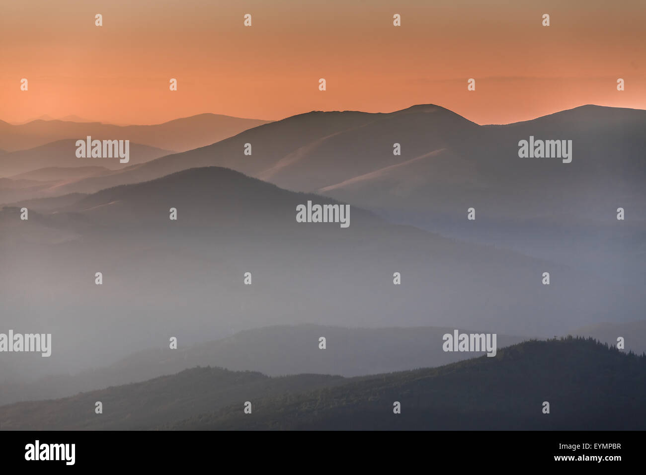 Distant mountain range and thin layer of clouds on the valleys, Ukraine ...