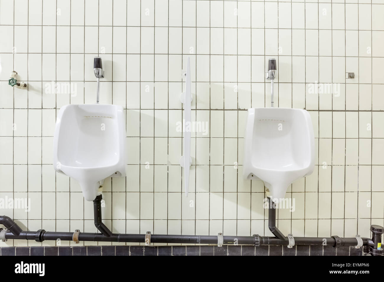 urinals in an old building for men only Stock Photo - Alamy