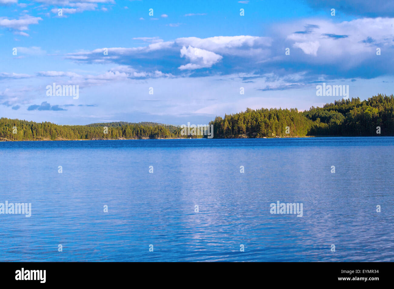 Lake summer view with reflection of clouds on water surface, Finland ...