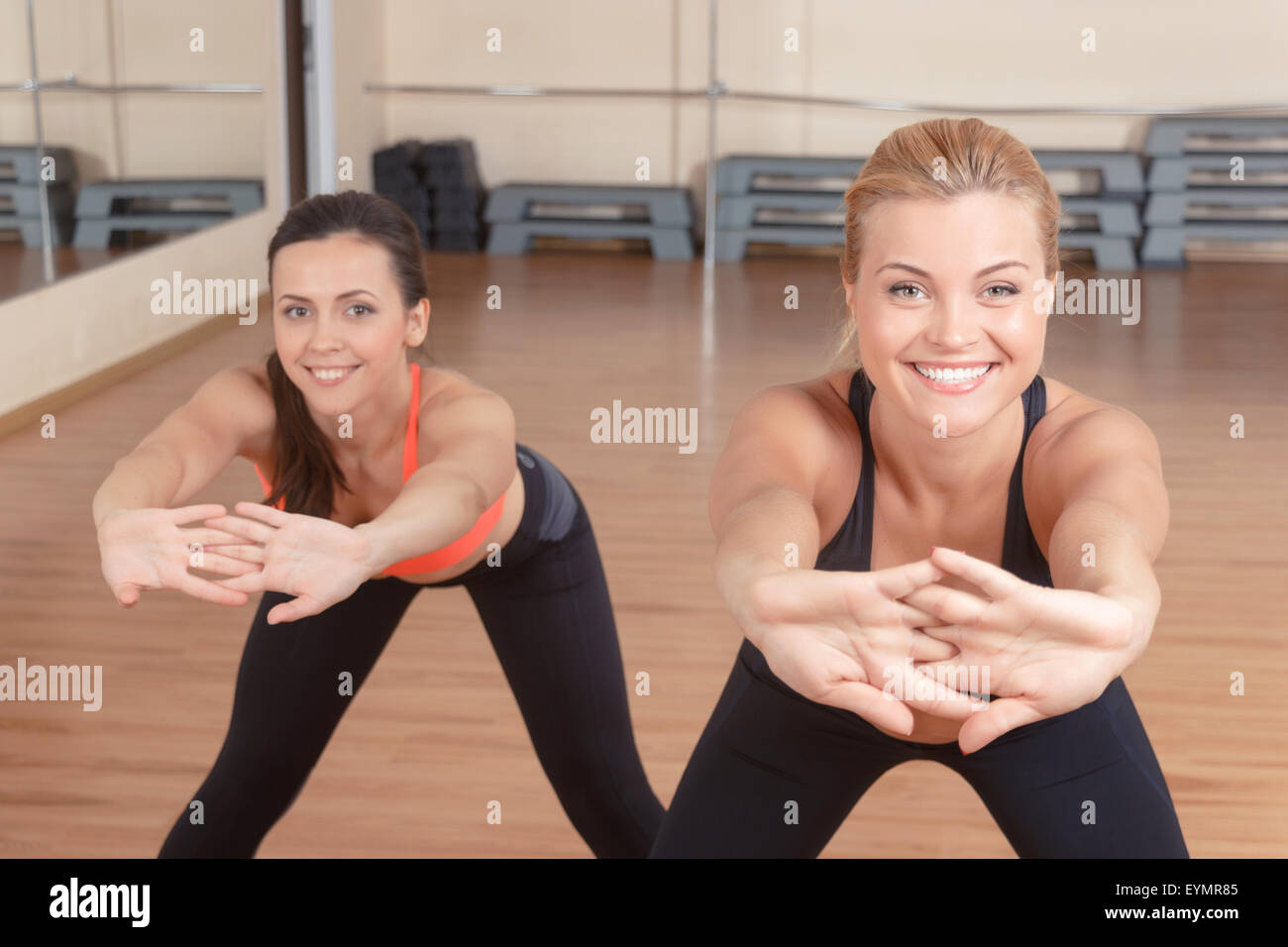 Pair f women stretching forward Stock Photo - Alamy