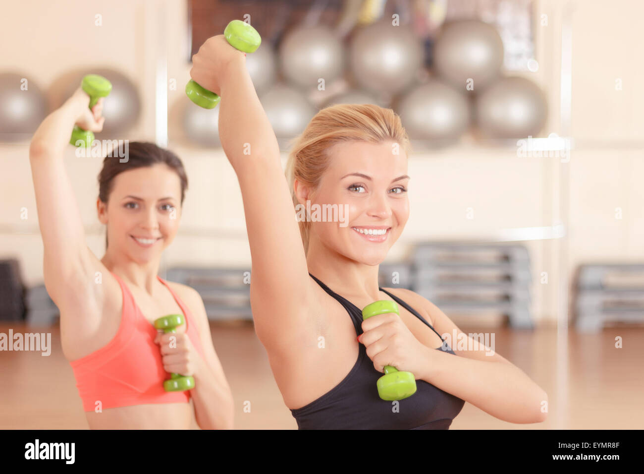 Pair of women doing weights fitness Stock Photo - Alamy