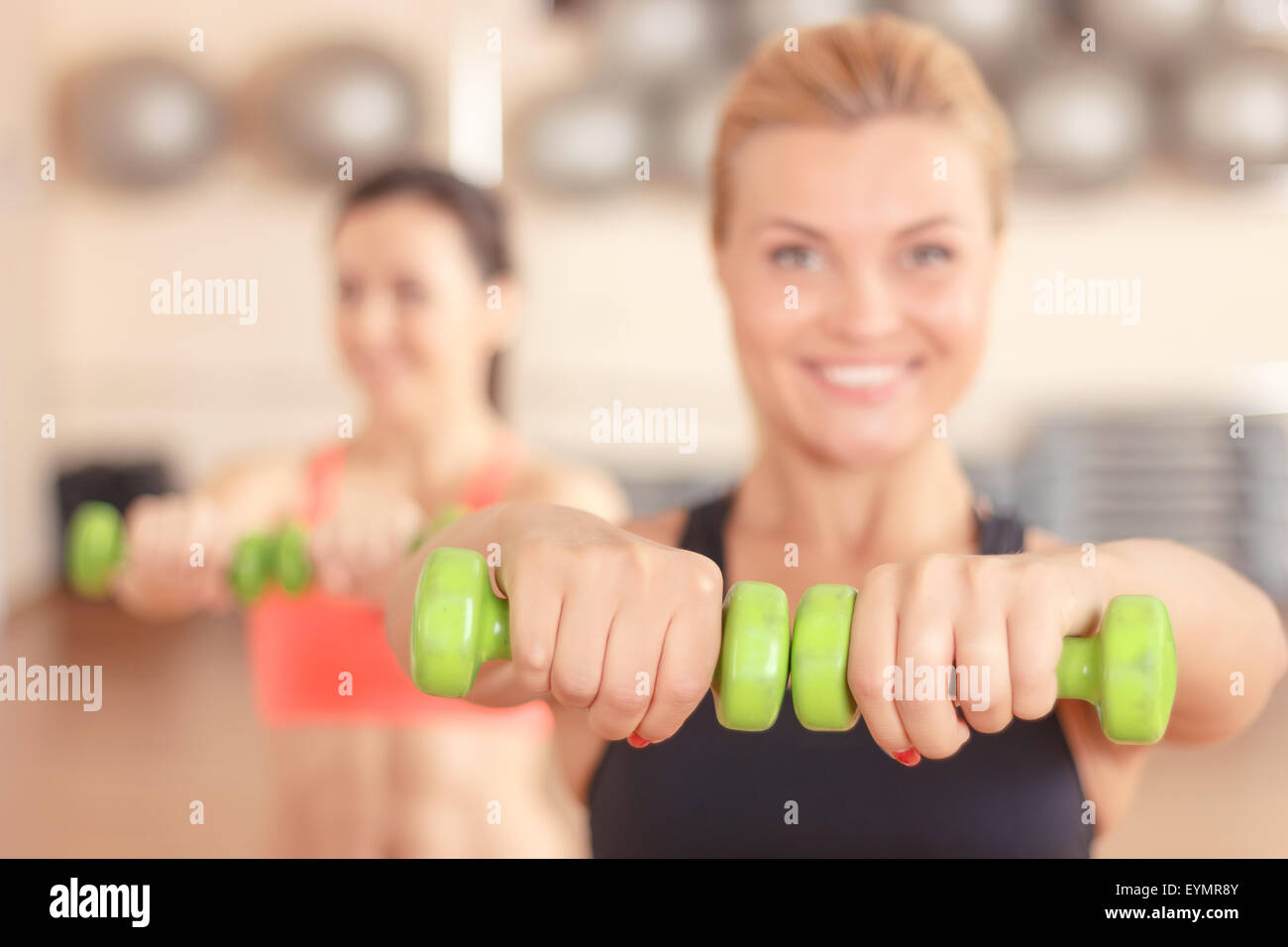 Pair of women doing weights fitness Stock Photo - Alamy