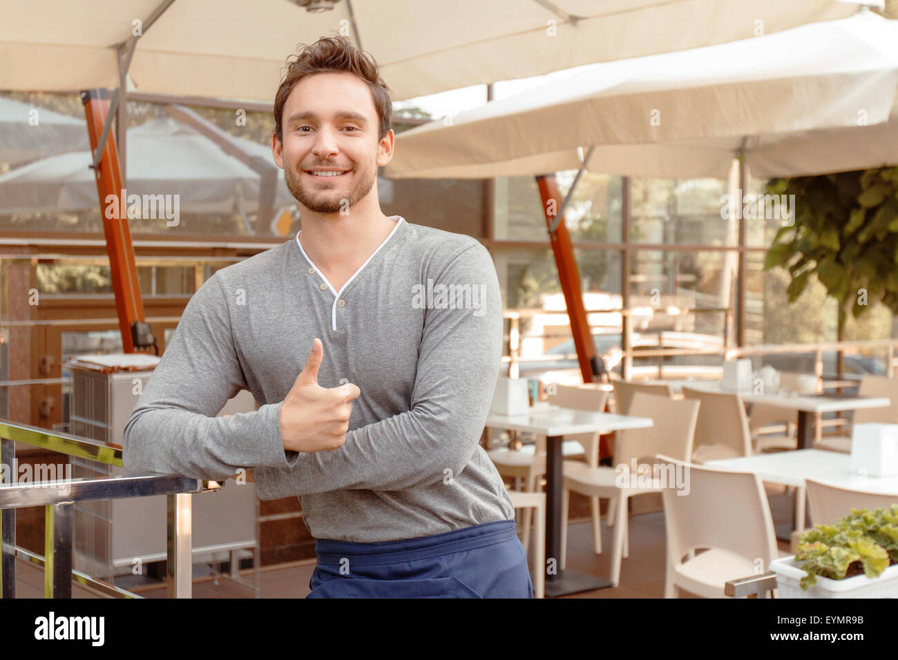 Handsome waiter with thumbs up Stock Photo - Alamy