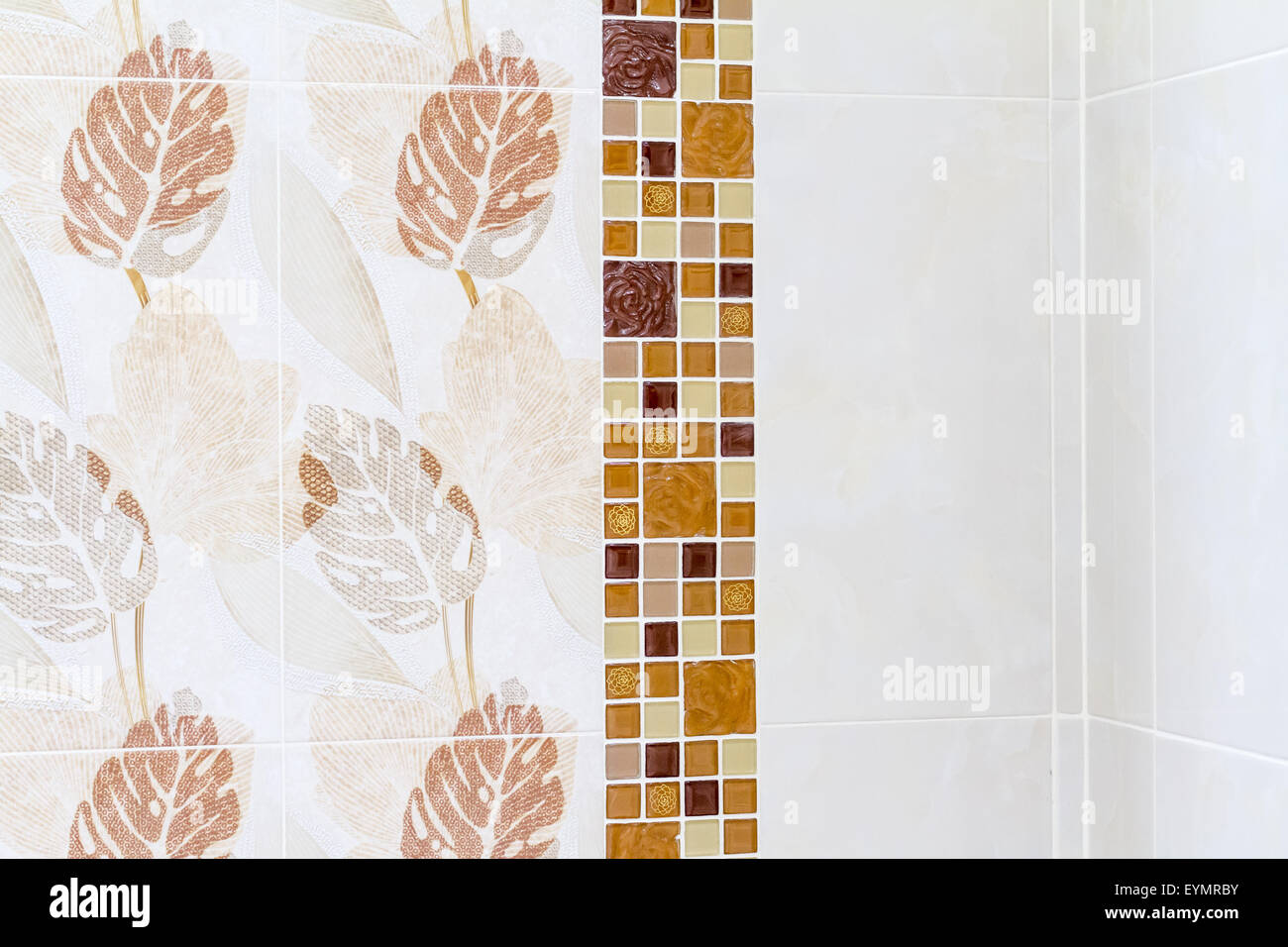leaves motif tile wall with an angle with white tiles Stock Photo - Alamy
