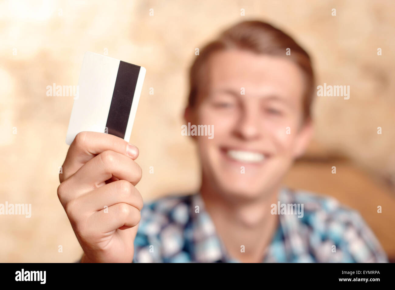 Smiling man showing his credit card Stock Photo - Alamy