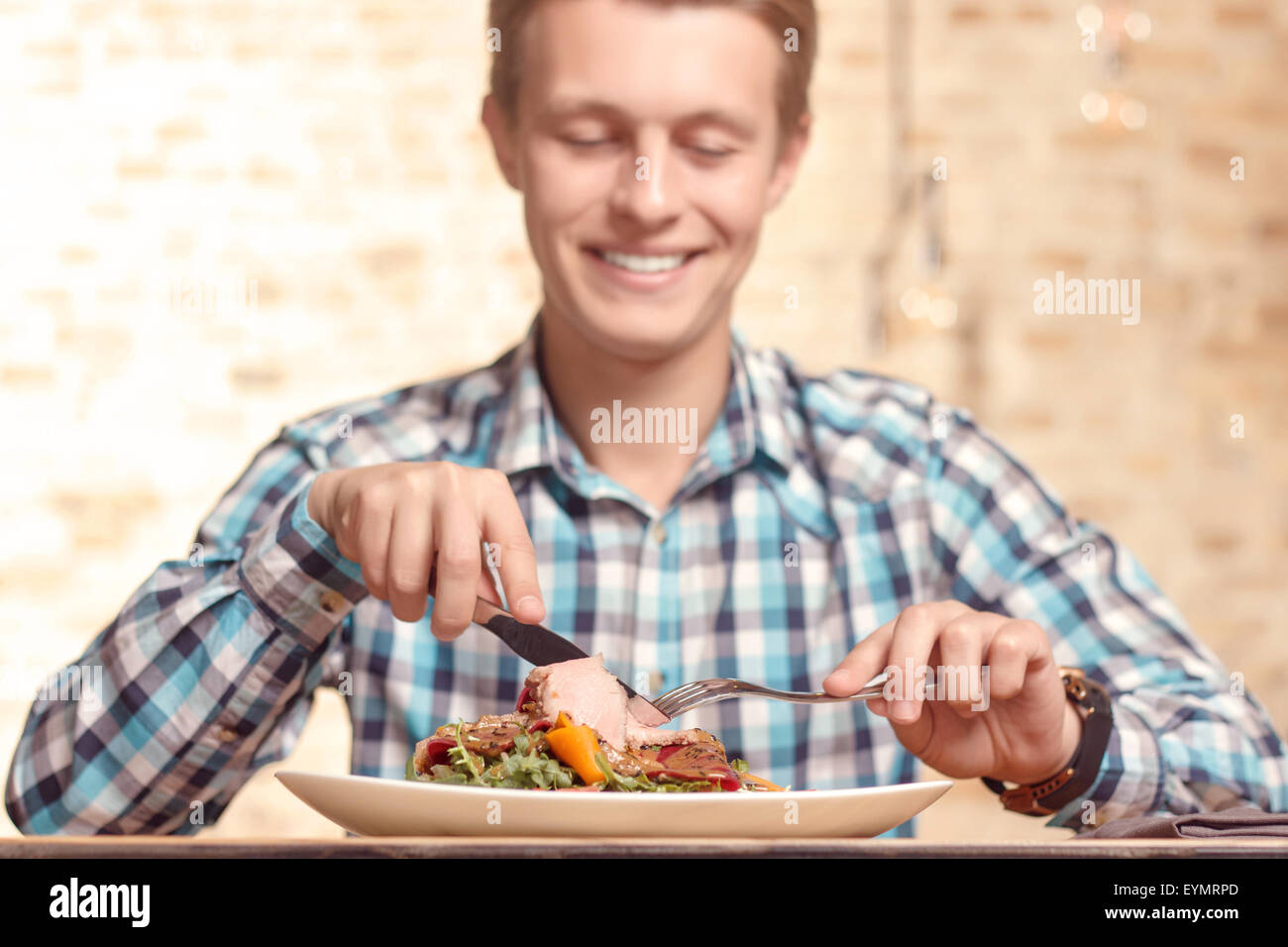 Handsome man eating fork knife hi-res stock photography and images - Alamy