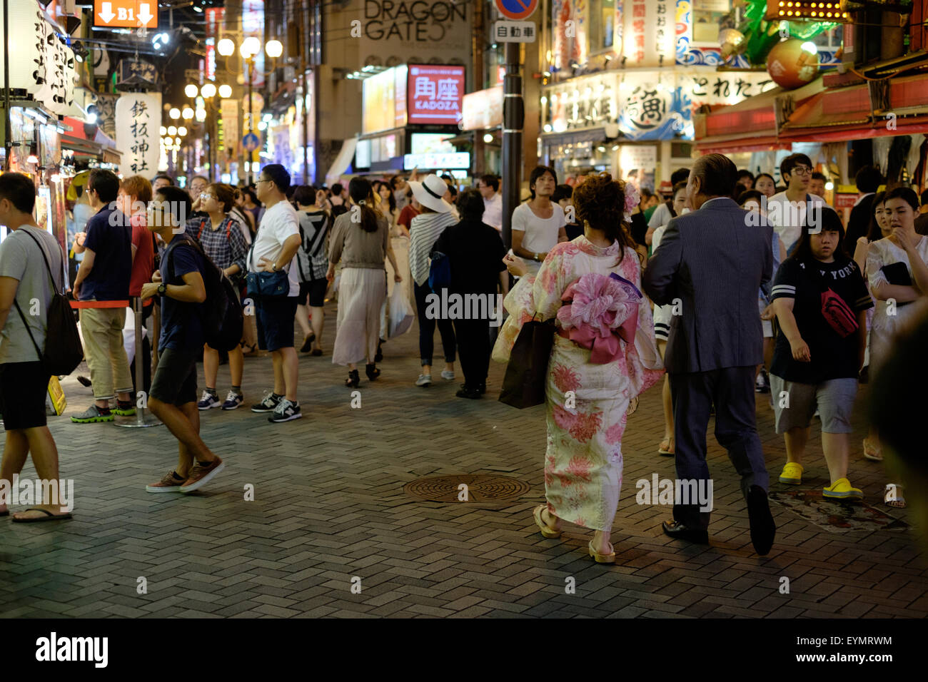 Busy street in Osaka full of tourists and locals shopping and dining ...