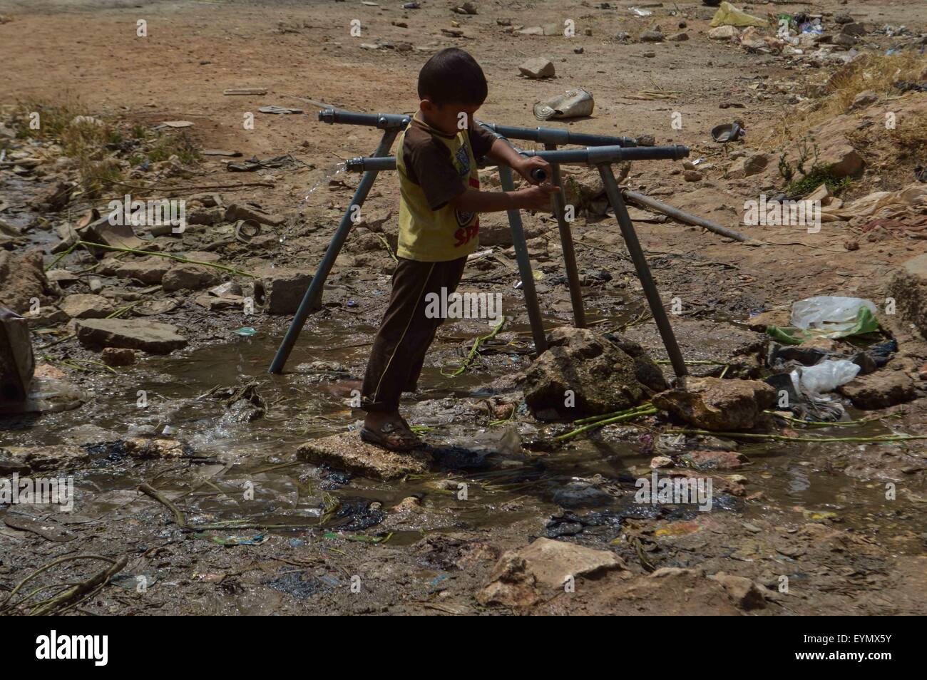 Aleppo, Syria. 30th July, 2015. A displaced Syrian boy plays at the ...