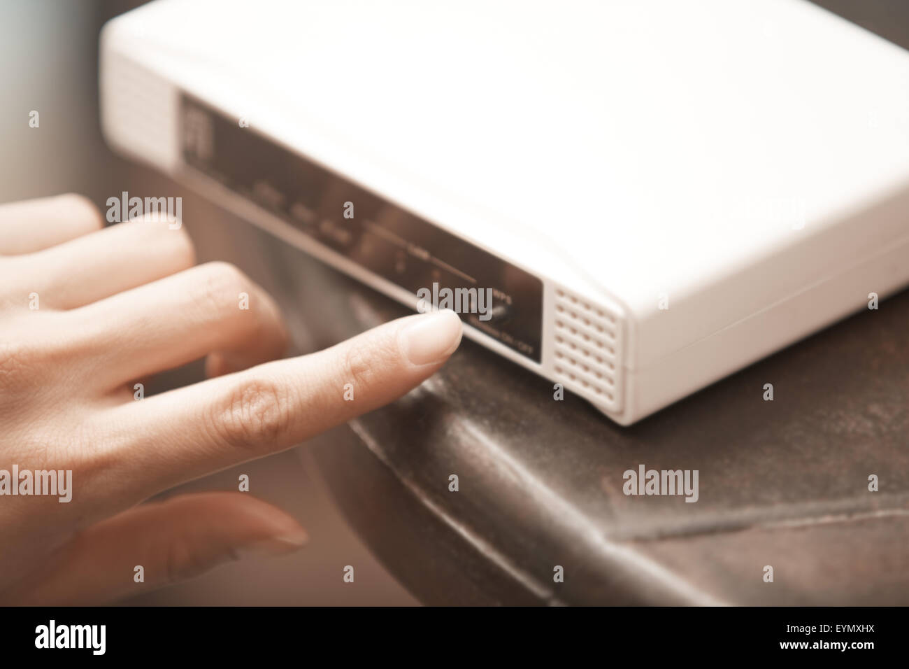 Human hand turning on wireless modem. Close-up horizontal photo Stock ...