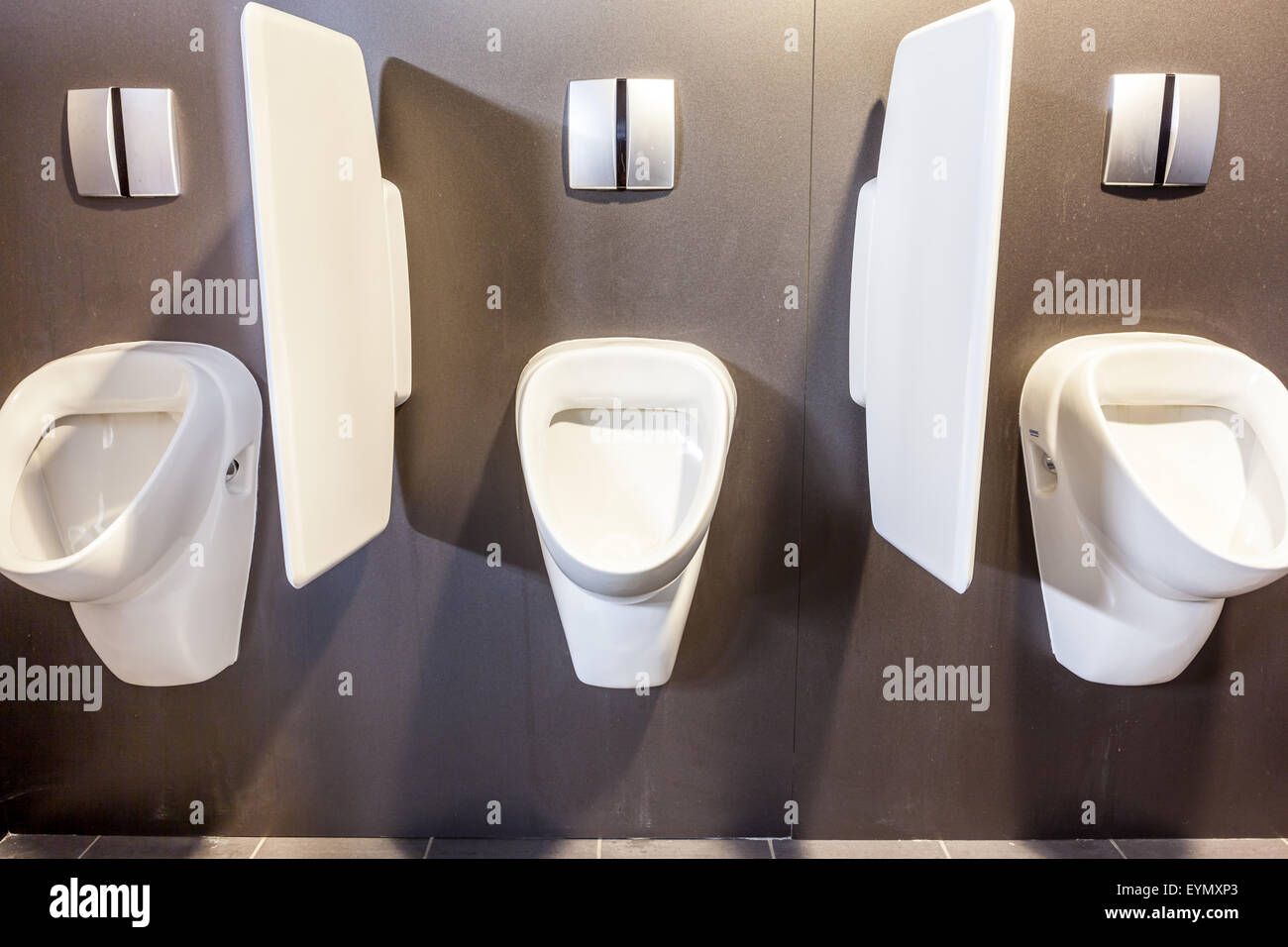 urinals in an new building for men only Stock Photo - Alamy