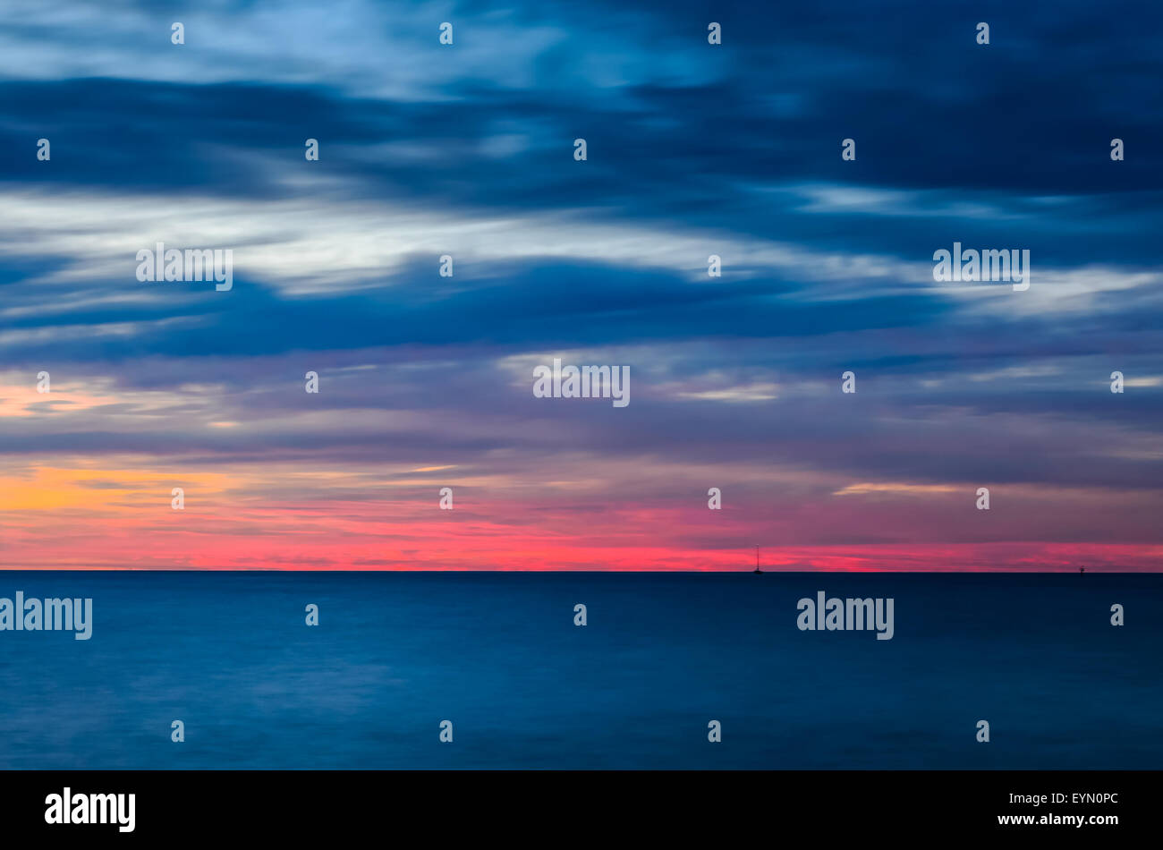 Long exposure sunset above the sea with a yacht on the horizon Stock ...