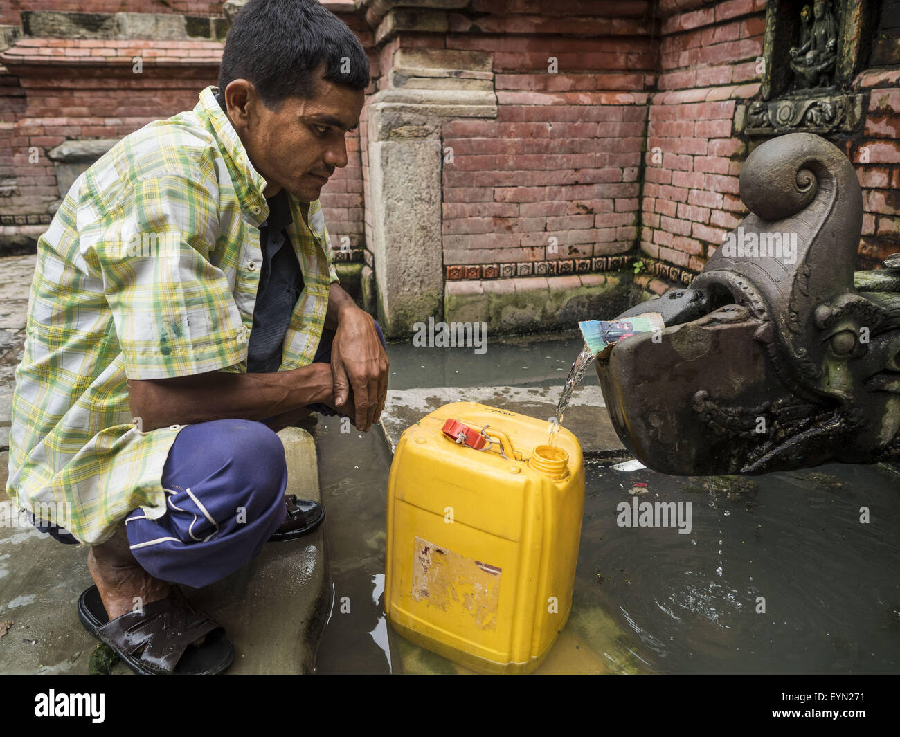 Aug. 1, 2015 - Kathmandu, Nepal - A man gets water from a public well ...