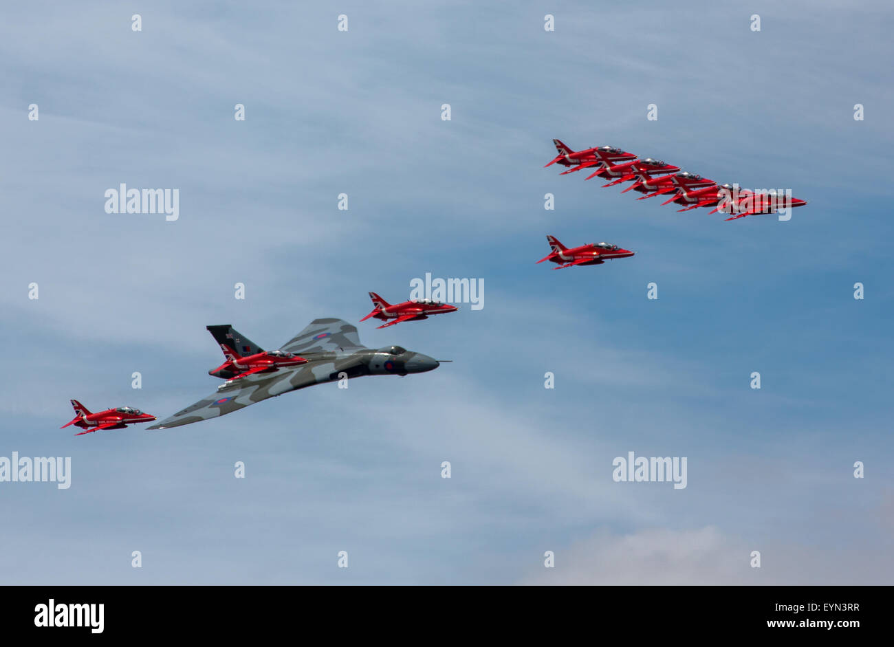 An historic Avro Vulcan V Bomber with a Red Arrow escort making a fly ...