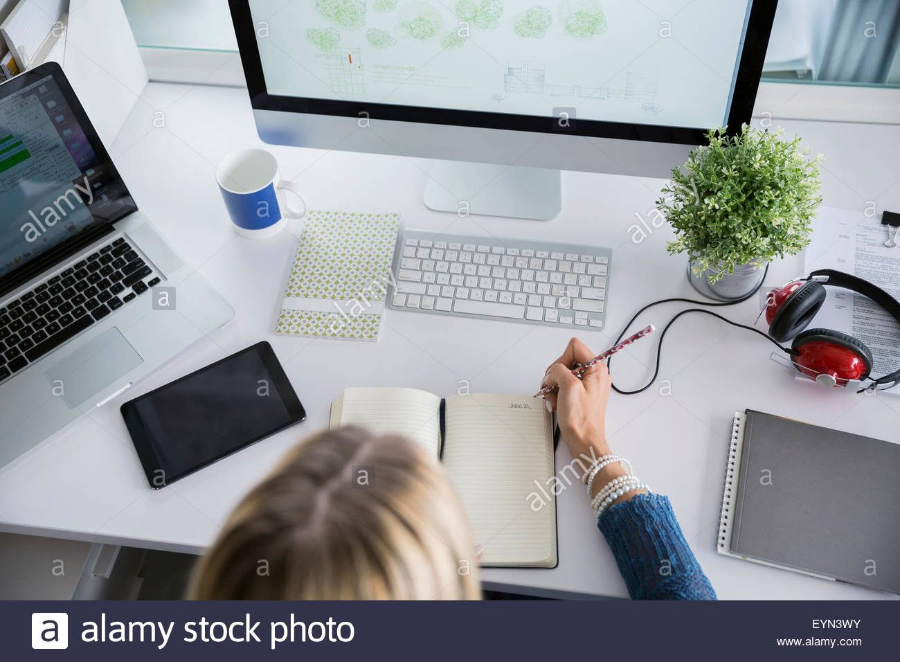 Overhead view architect writing in journal at desk Stock Photo - Alamy