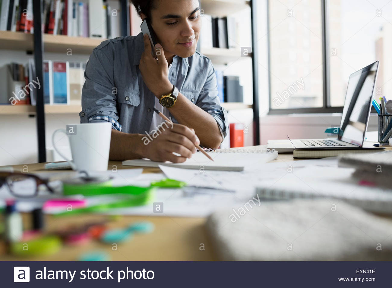 Architect talking on cell phone and drafting blueprints Stock Photo - Alamy