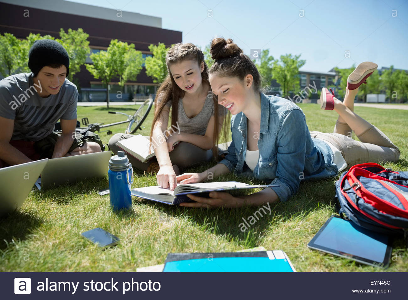 Three students studying on grass hi-res stock photography and images ...