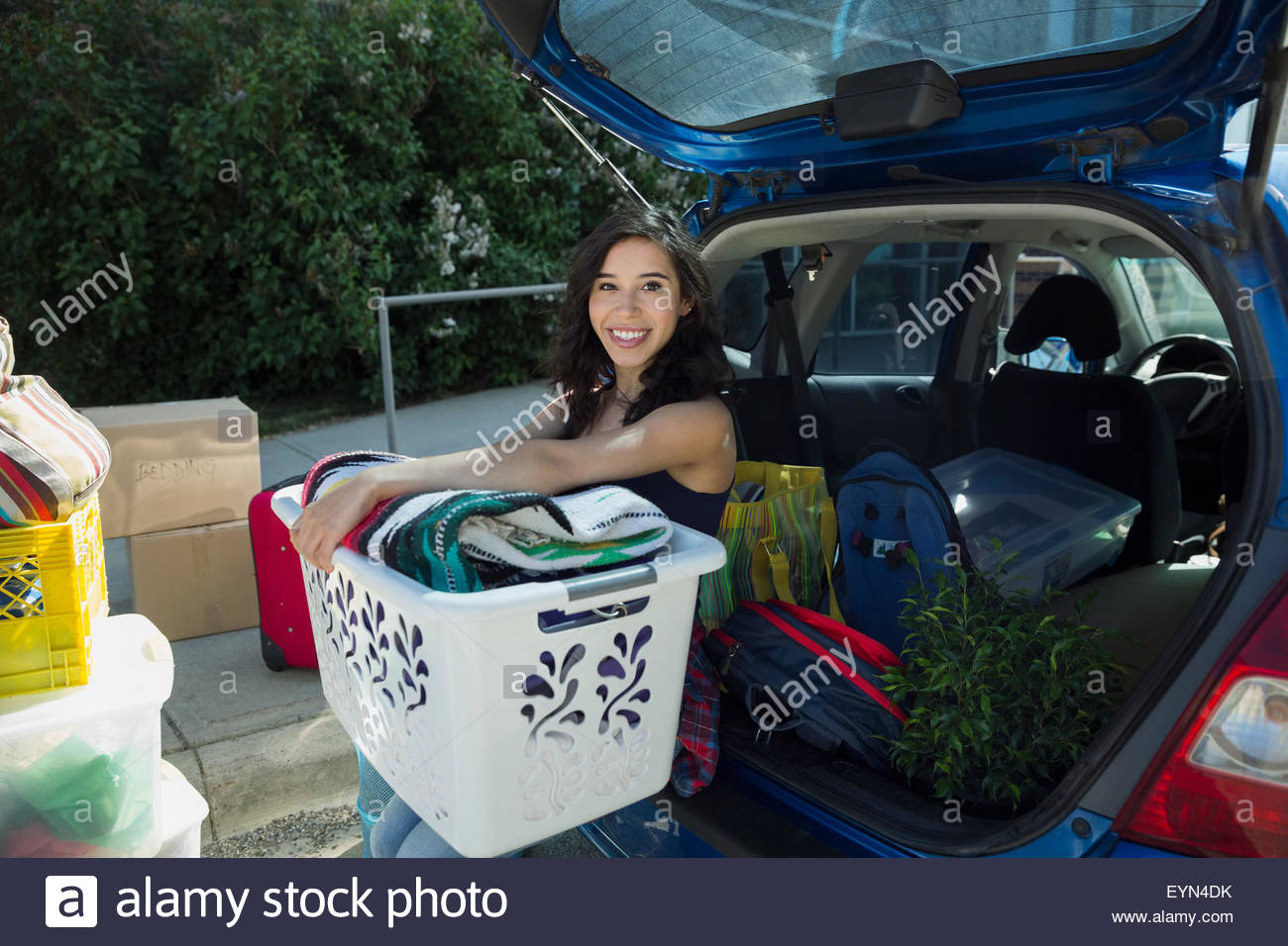 Portrait confident college student moving into college dorm Stock Photo ...