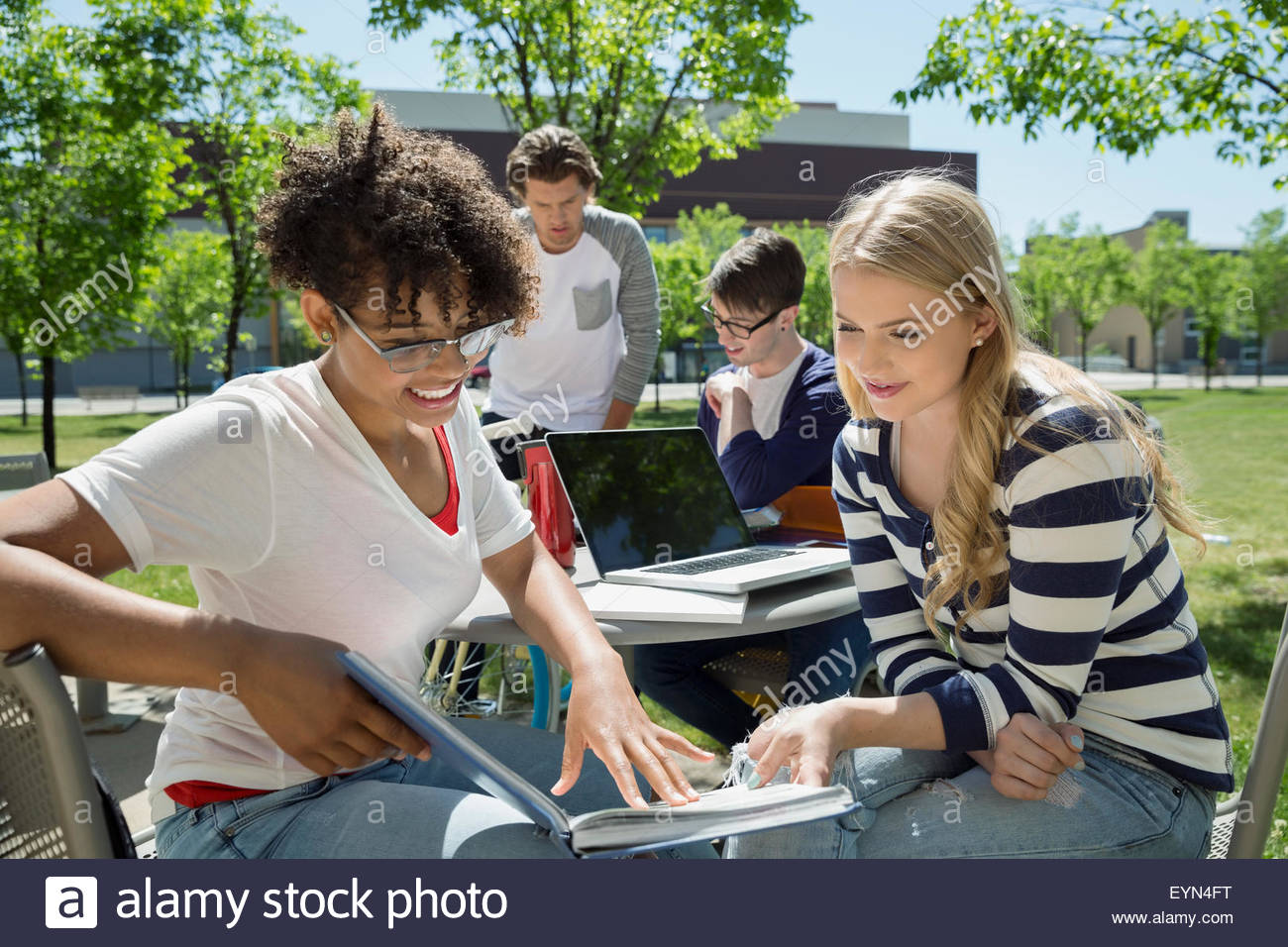 Group college students sitting table hi-res stock photography and ...