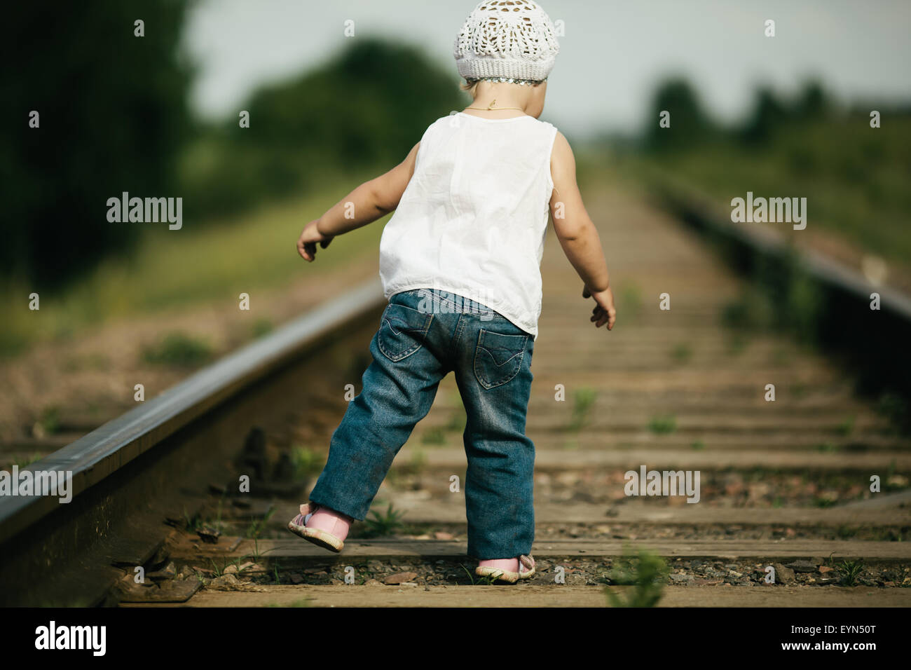 little girl plays on railroad Stock Photo - Alamy