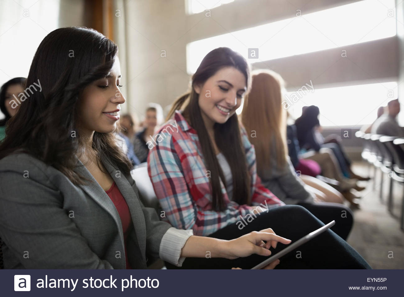 Students using digital tablet in auditorium audience Stock Photo - Alamy