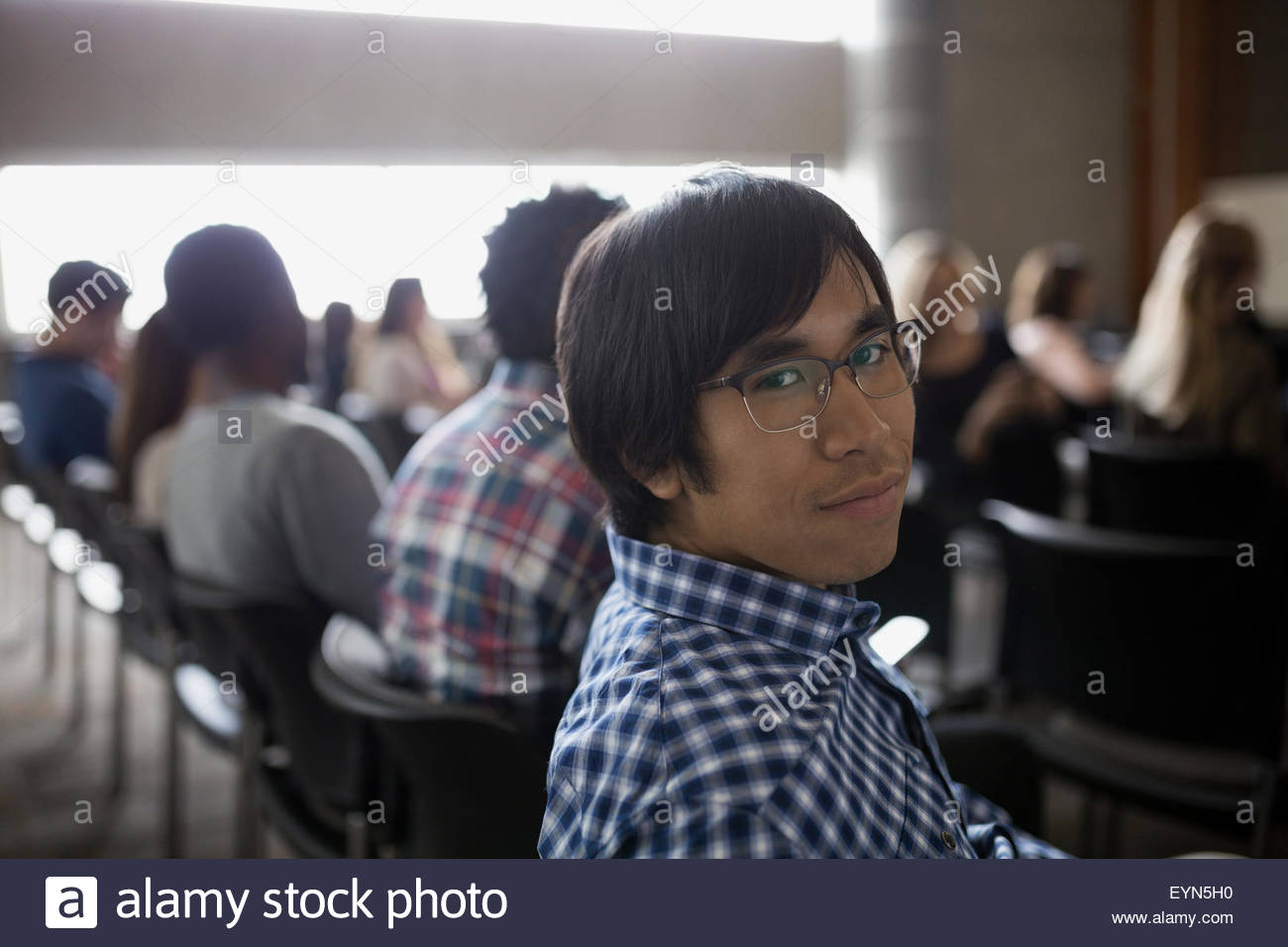 Portrait confident student sitting in auditorium audience Stock Photo ...