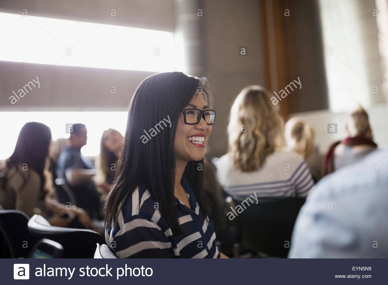 Enthusiastic student in auditorium audience Stock Photo - Alamy