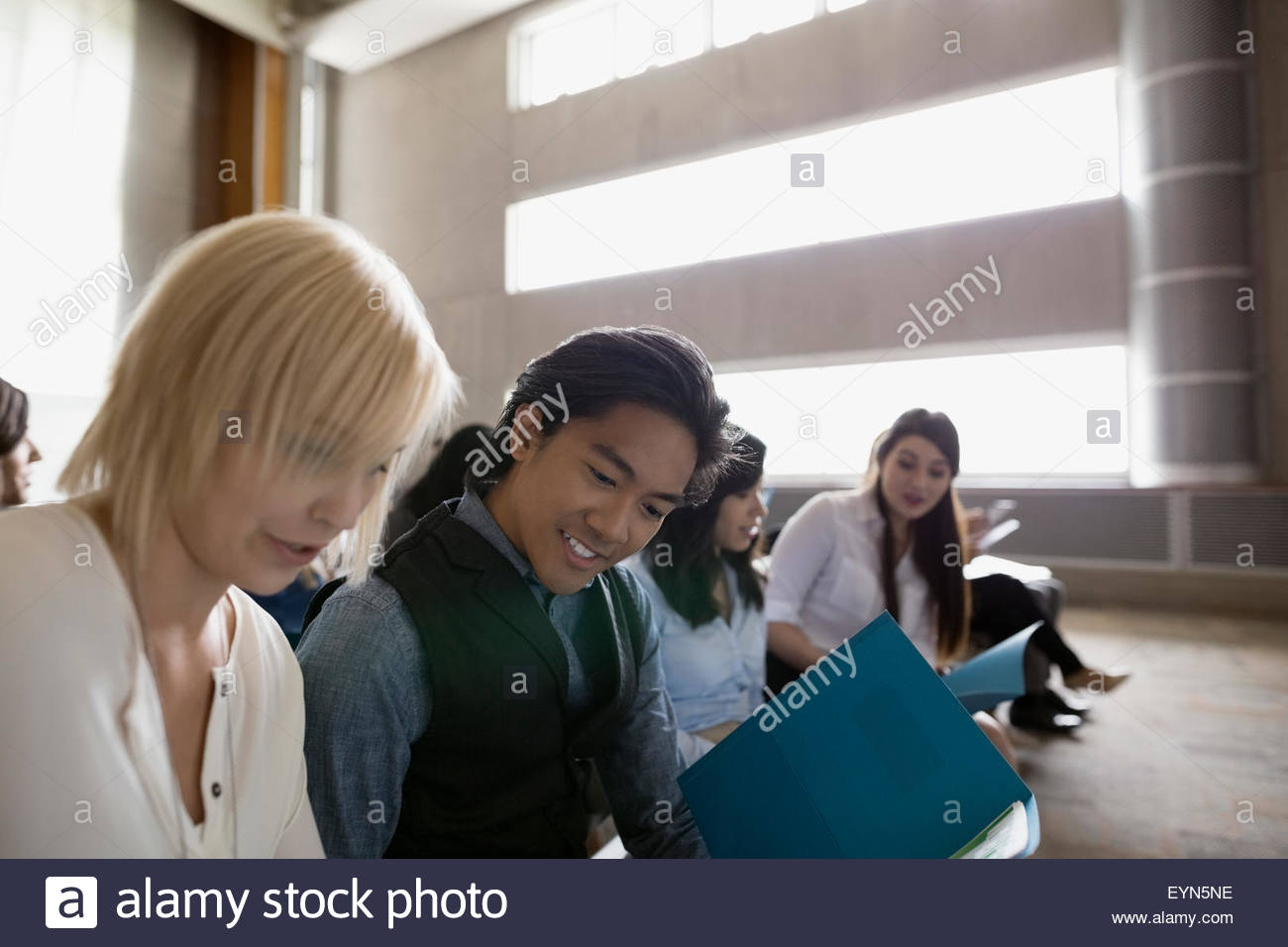 Students talking in lecture audience in auditorium Stock Photo - Alamy