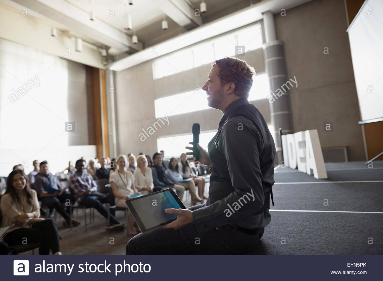 Speaker sitting addressing audience stage near Idea text Stock Photo ...
