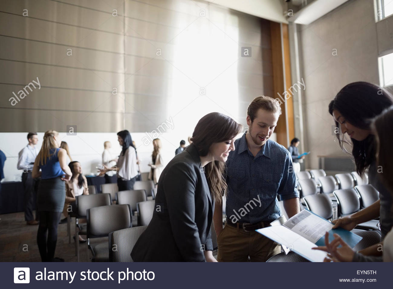 Students reviewing information in auditorium audience Stock Photo - Alamy