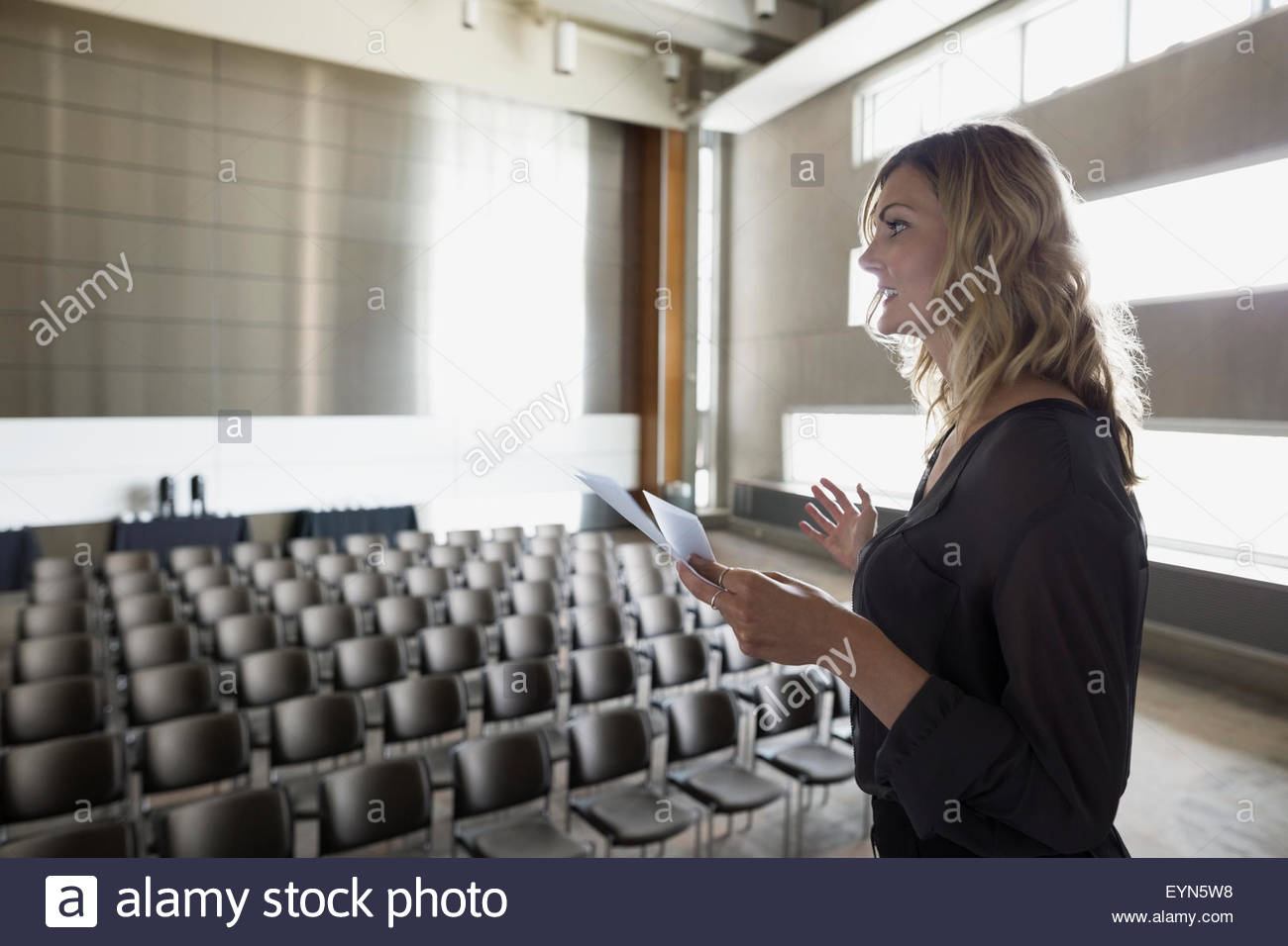 Woman standing in hall hi-res stock photography and images - Alamy