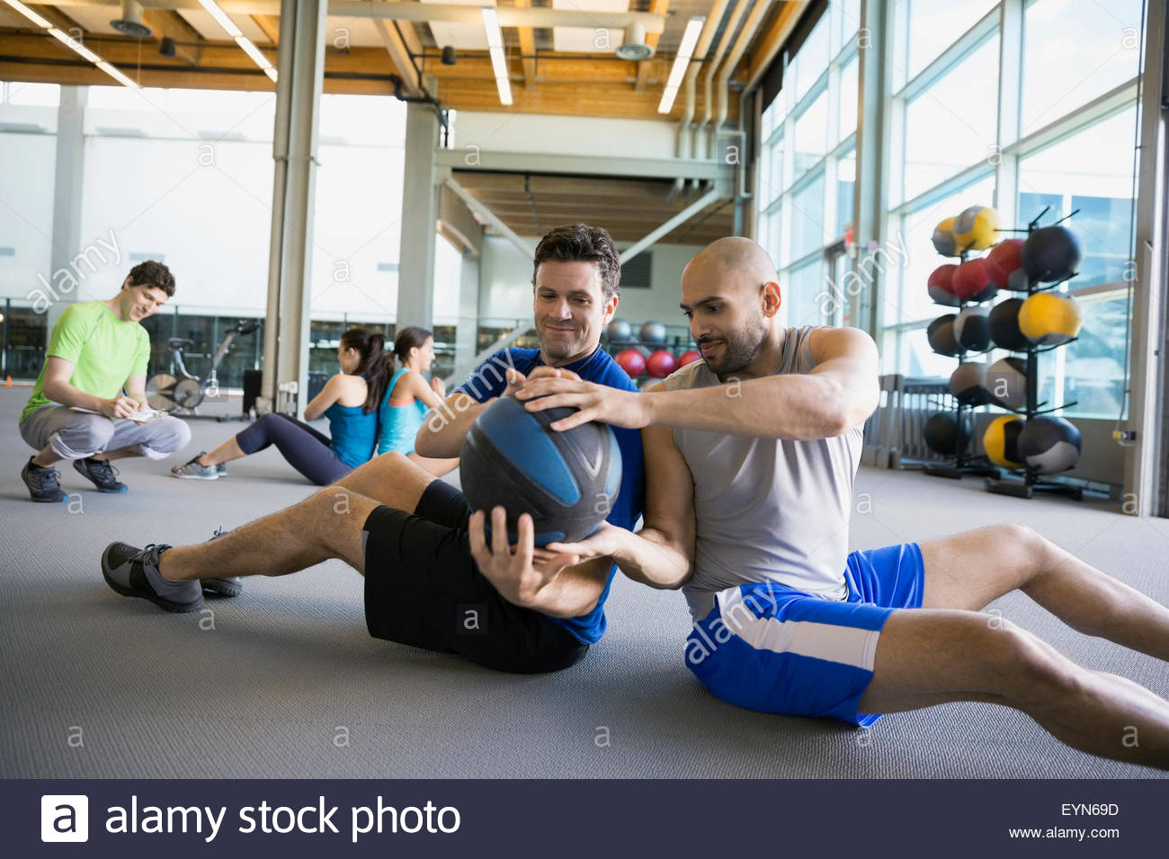 Men medicine ball full twist back to back Stock Photo - Alamy