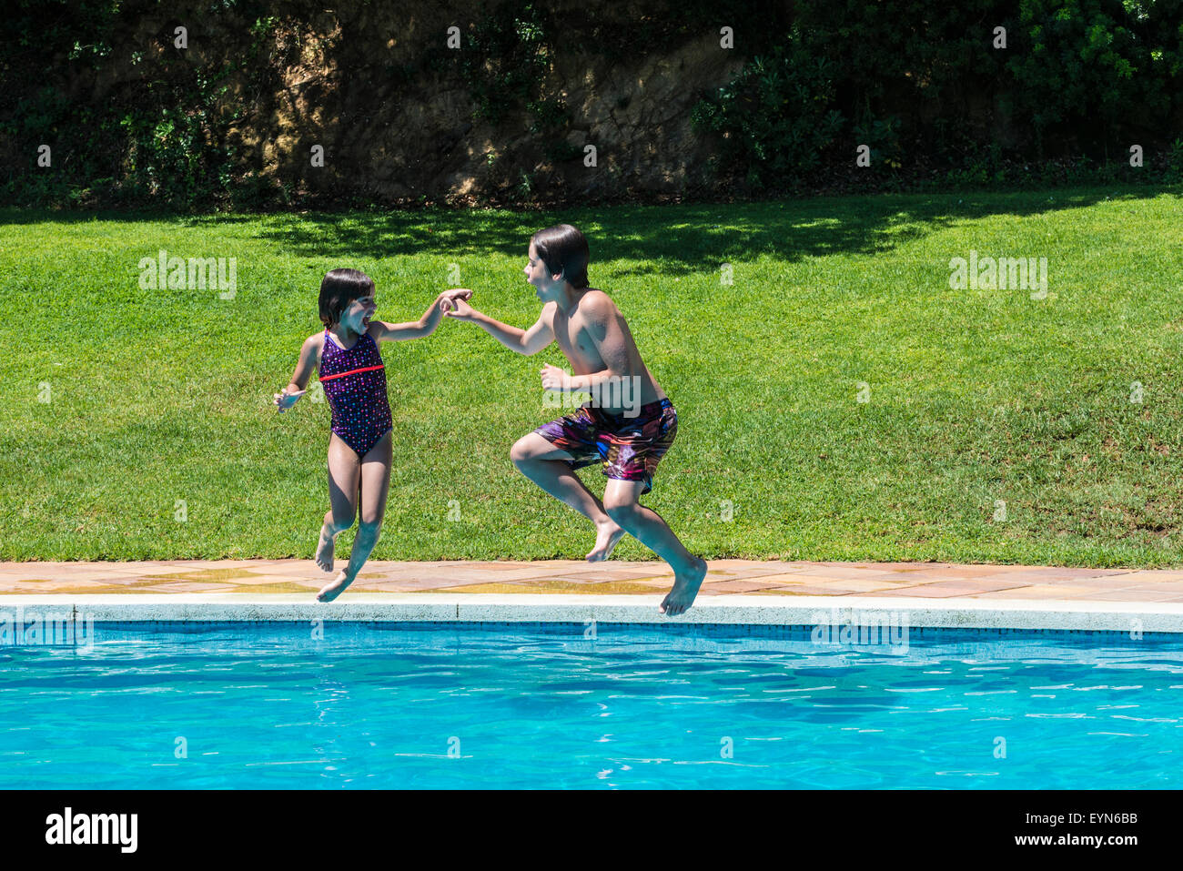 Family jumping into pool hi-res stock photography and images - Alamy