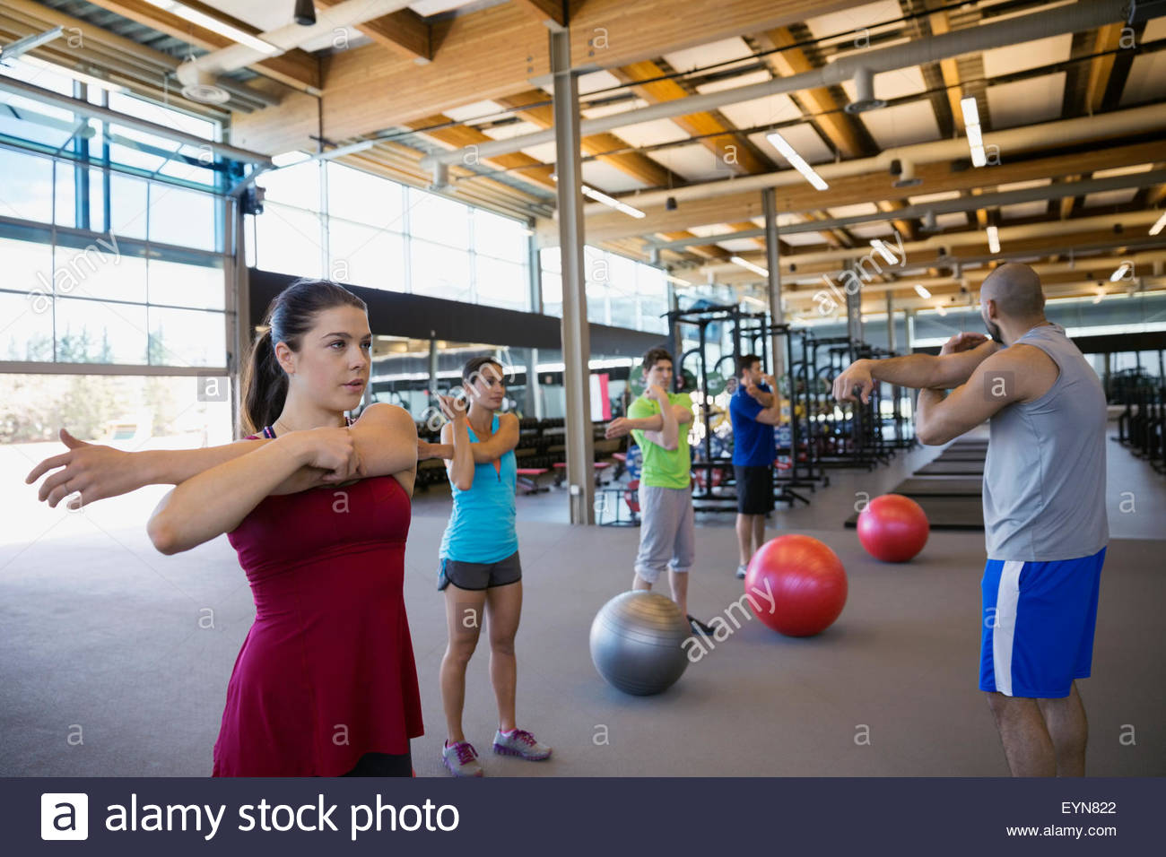 Exercise class stretching arms in gym Stock Photo - Alamy