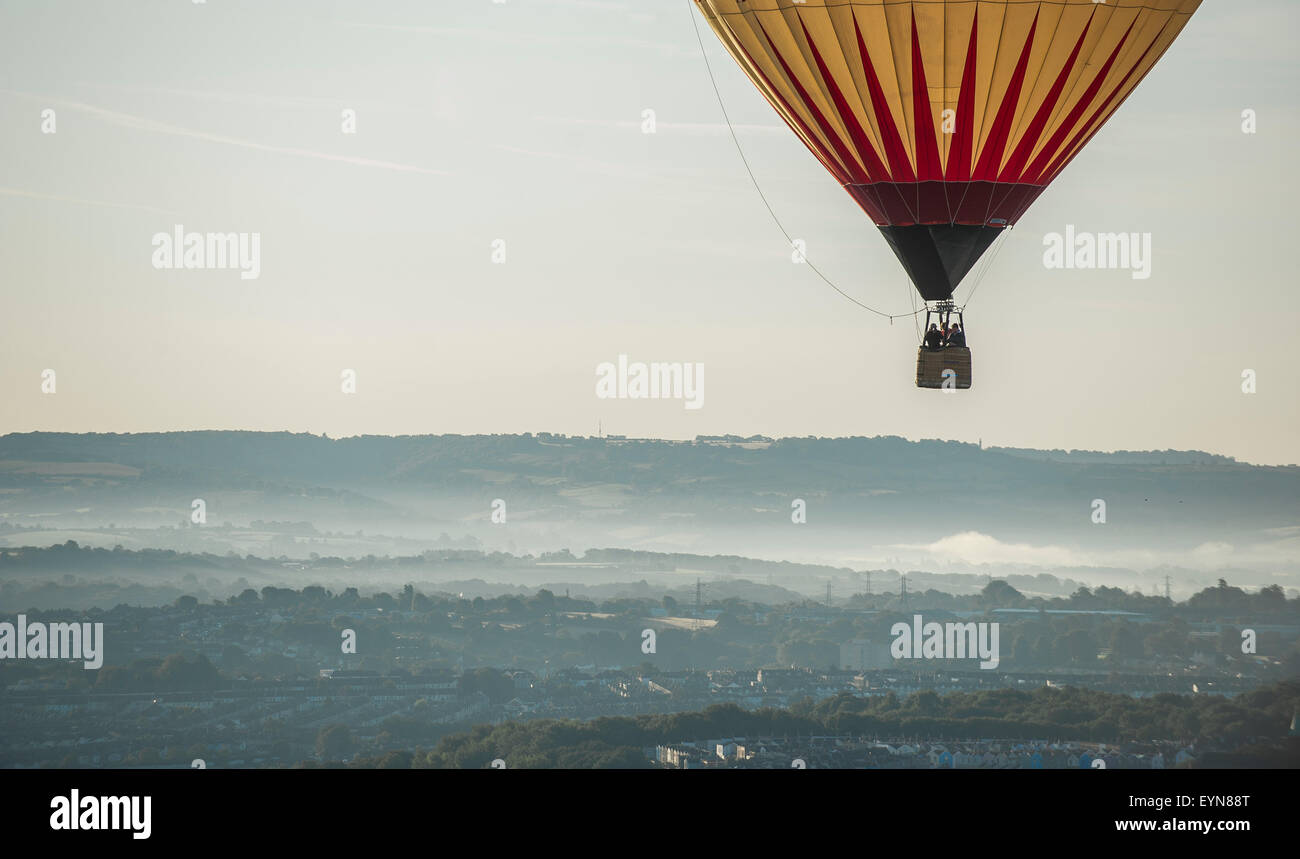 Hot air balloons fly over the city of Bristol in the early morning ...