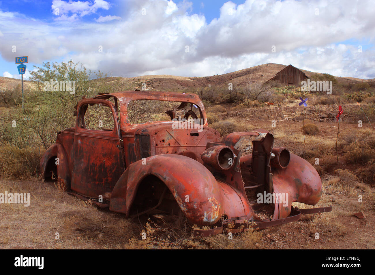 Old car rusting in Desert Landscape with Barn in Background Stock Photo ...