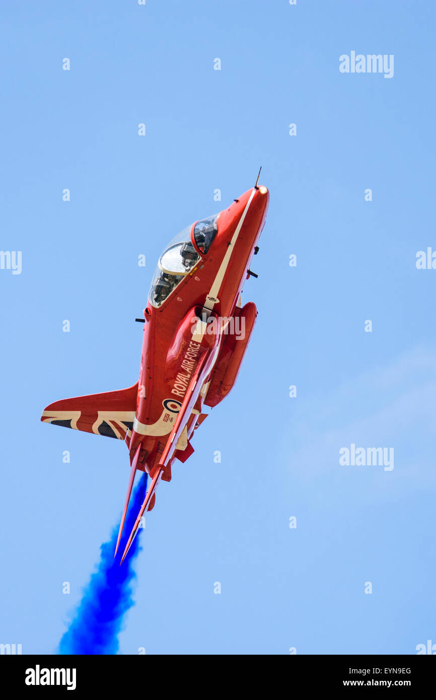 Single RAF Red Arrow passing low overhead during an airshow display ...