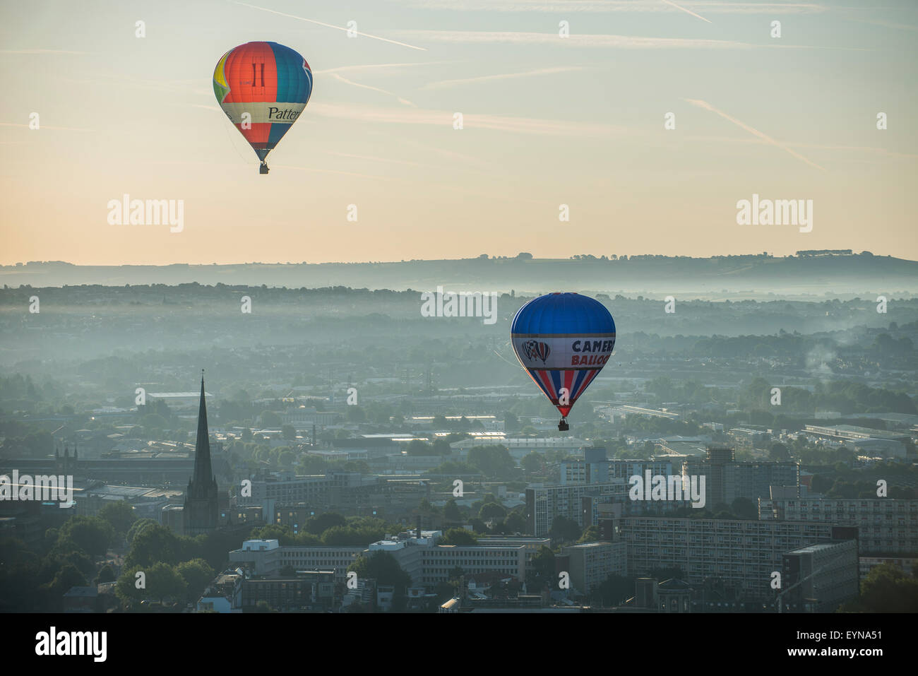 Hot air balloons fly over the city of Bristol in the early morning ...