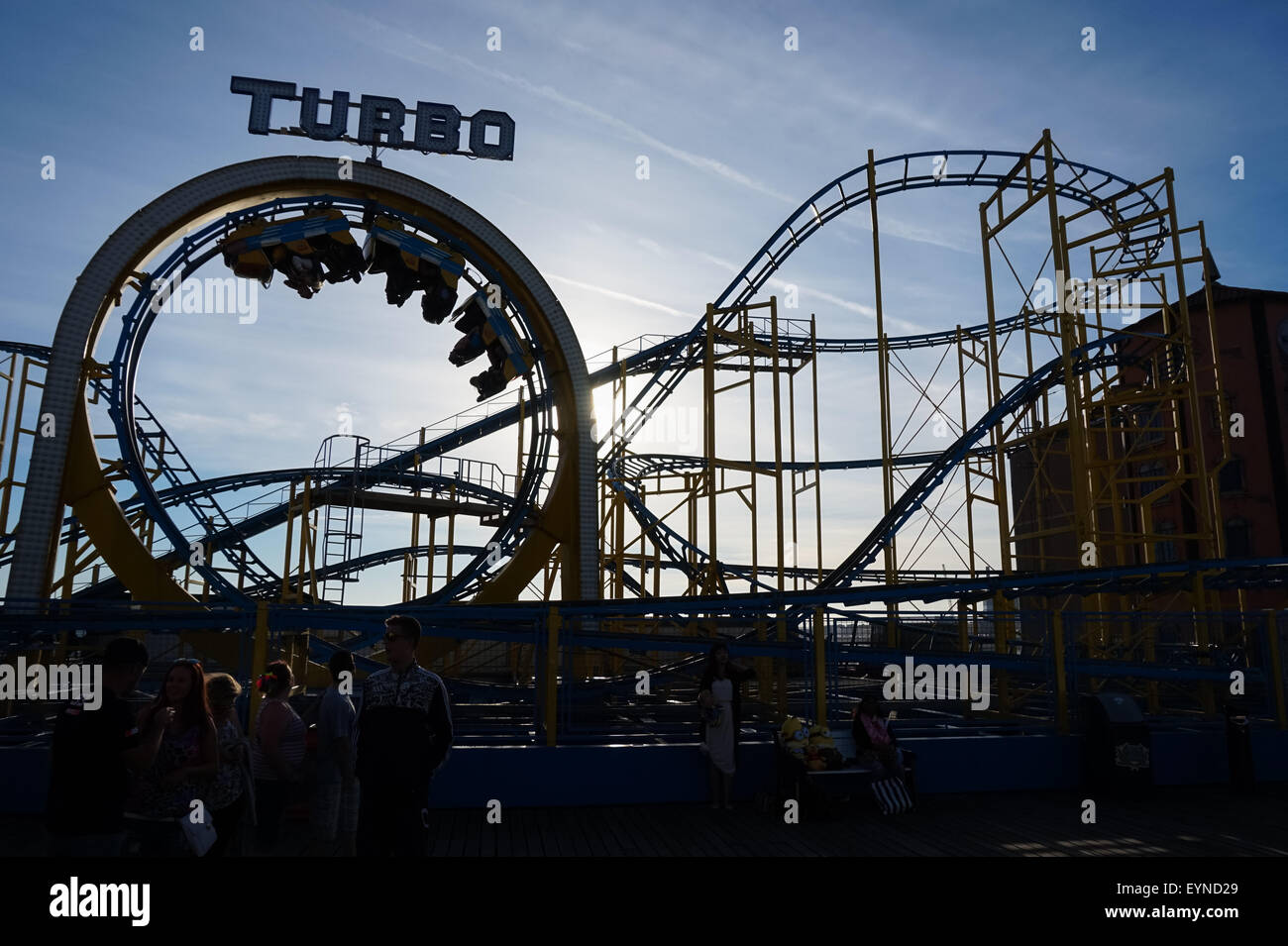 People enjoying Turbo Coaster ride on Brighton Pier at sunset, Brighton ...