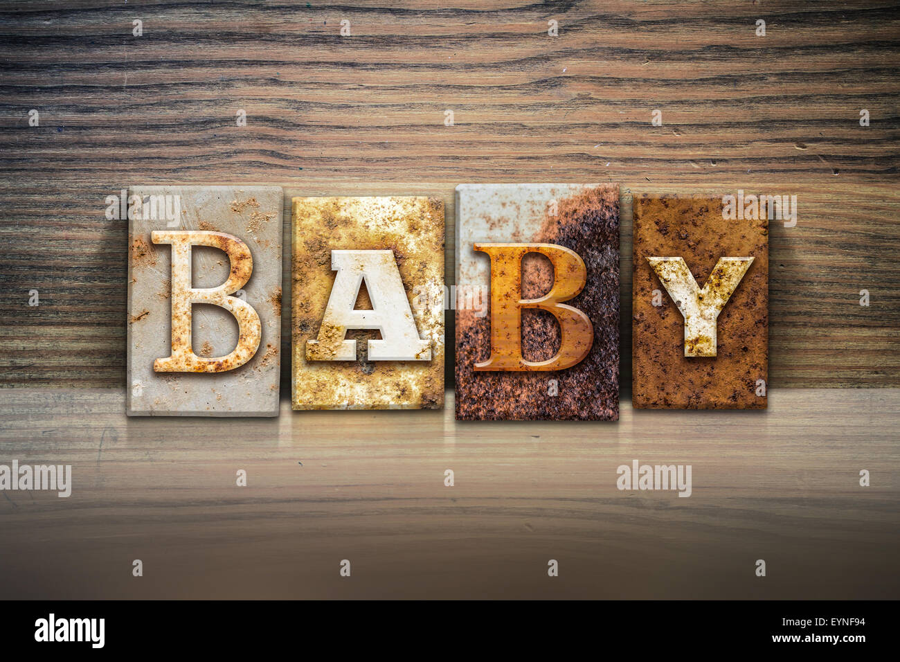 The word "BABY" written in rusty metal letterpress type sitting on a ...