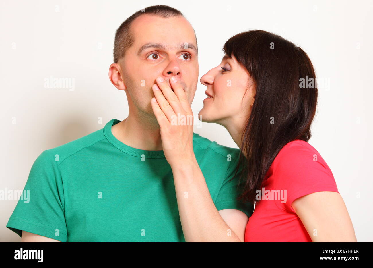 Shocked man receive an unexpected message from woman, hands covering ...