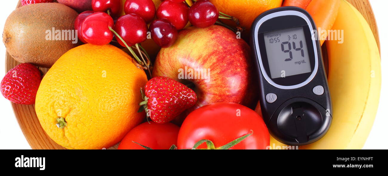 Glucose meter with fresh ripe fruits and vegetables, concept of ...