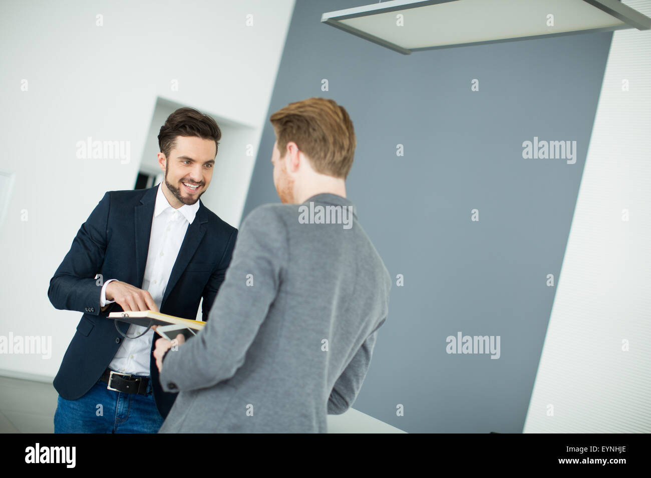 Young men in the office Stock Photo - Alamy