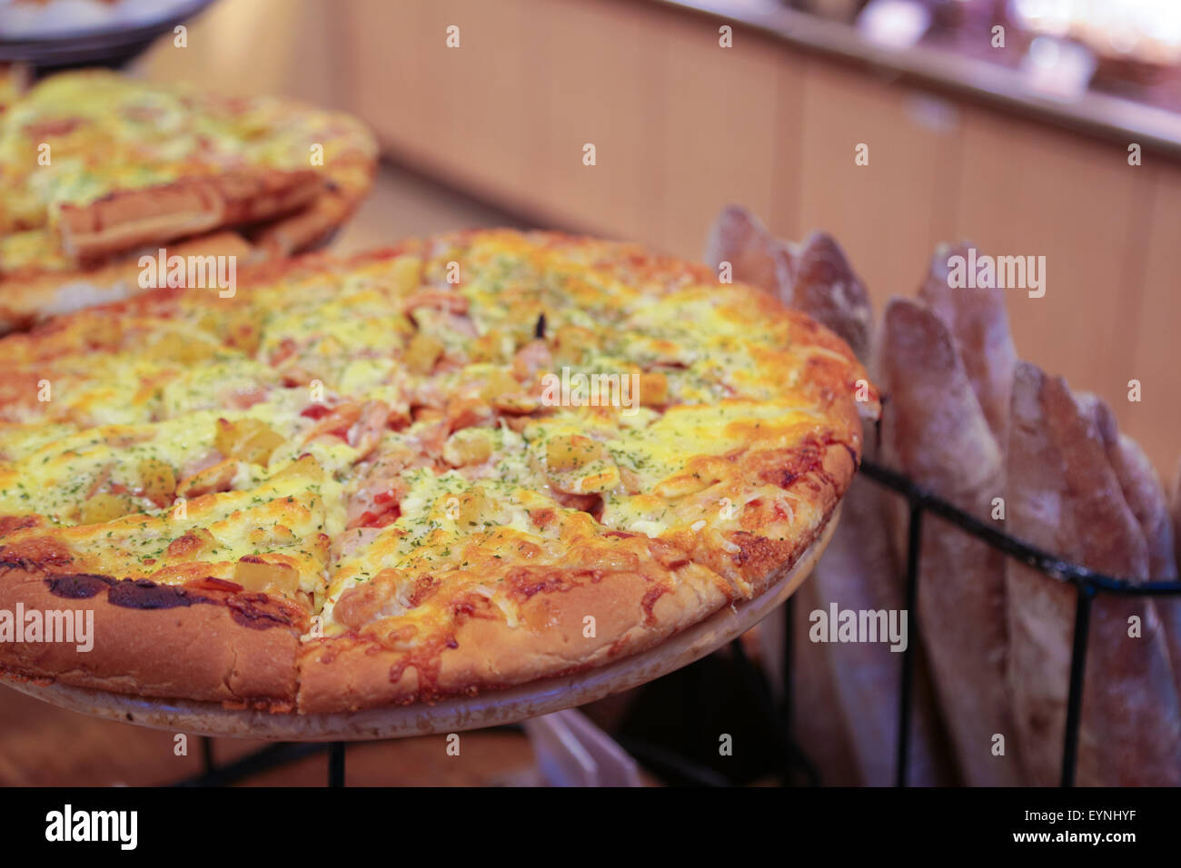 Freshly baked pizza at a bakery shop Stock Photo - Alamy