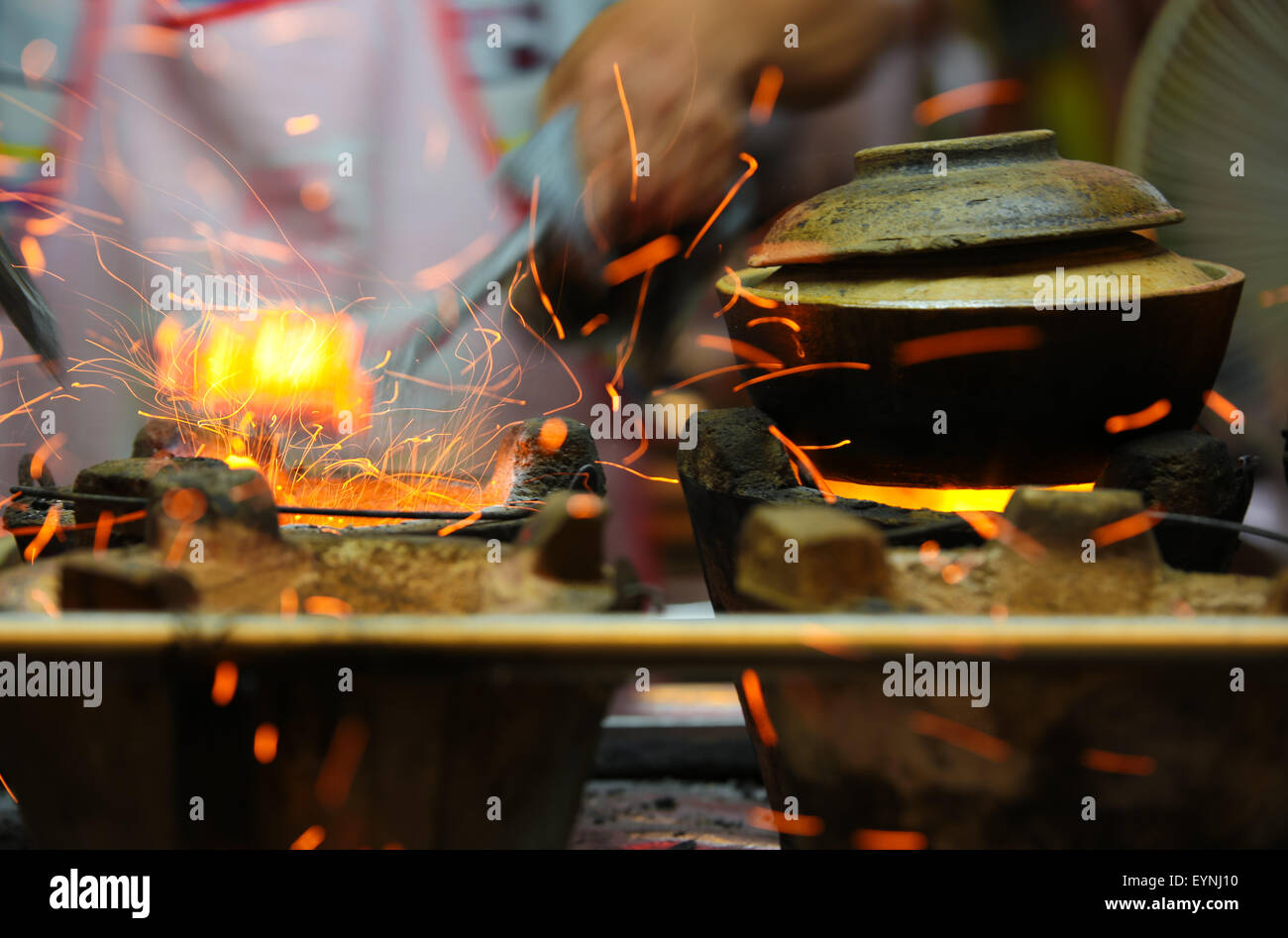 Clay pot meal preparation using charcoal fire Stock Photo - Alamy