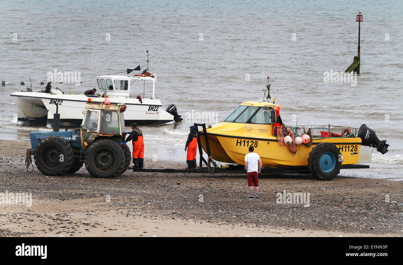 Fishing boats landing on the beach at Hornsea, east Yorkshire, UK Stock ...