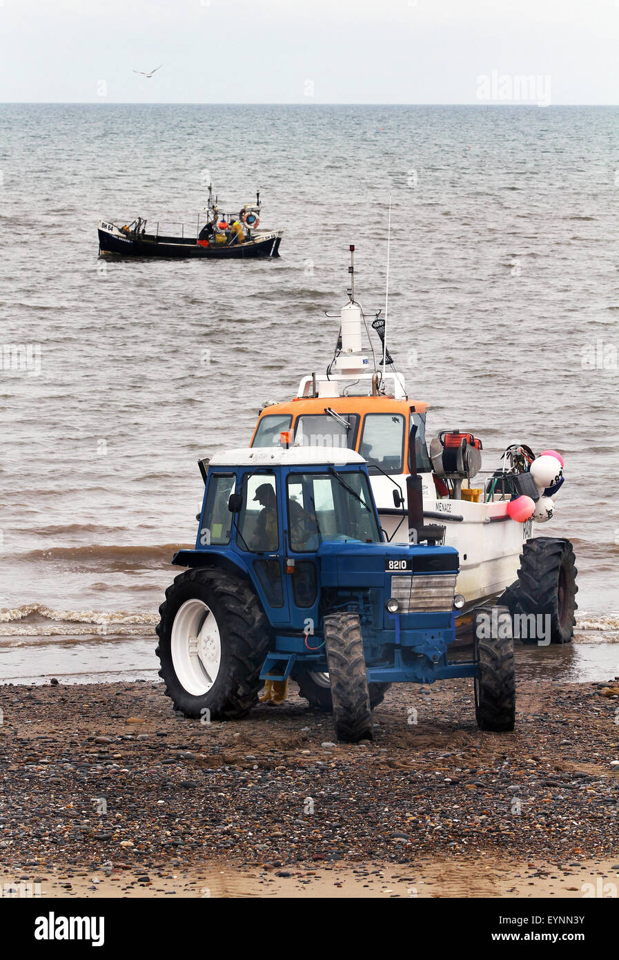 Fishing boats landing on the beach at Hornsea, east Yorkshire, UK Stock ...