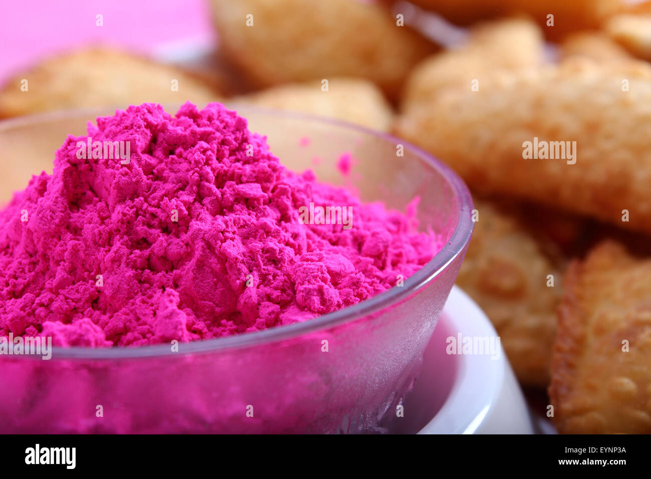 Pink Holi color with tradiional indian snacks gujiya Stock Photo - Alamy