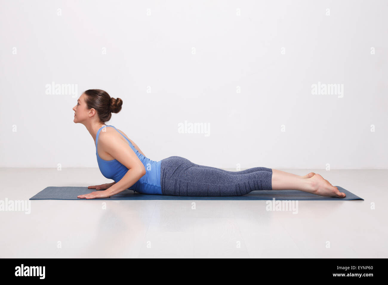 Sporty fit yogini woman practices yoga asana bhujangasana Stock Photo ...