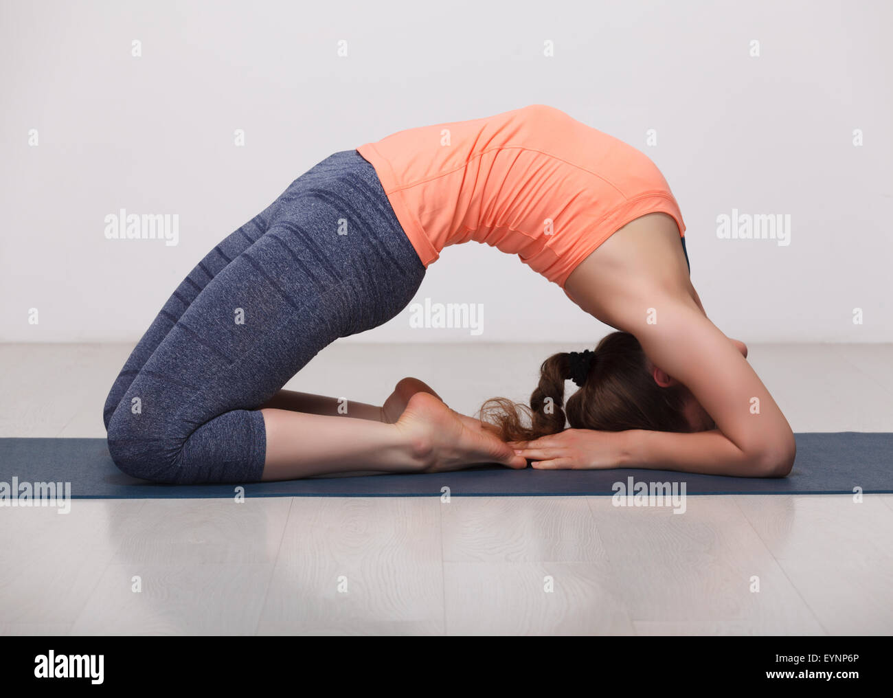 Beautiful sporty fit yogi girl practices yoga asana Kapotasana Stock ...