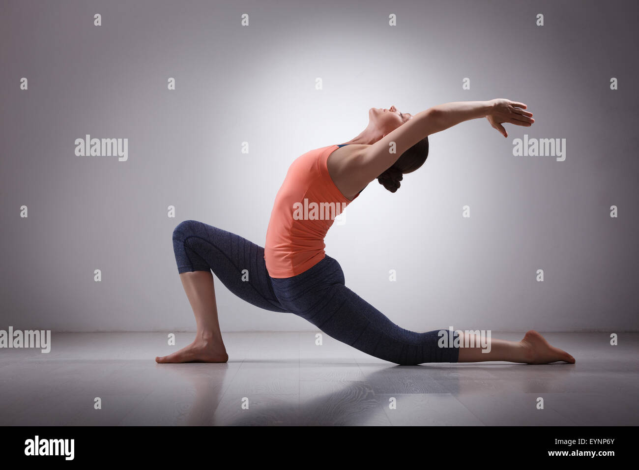 Fit yogini woman practices yoga asana Anjaneyasana Stock Photo - Alamy